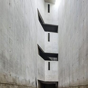 How do post-war architectural designs reflect the trauma and ...